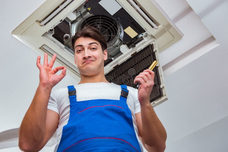 The Worker Repairing Ceiling Air Conditioning Unit Stock Image - Image ...