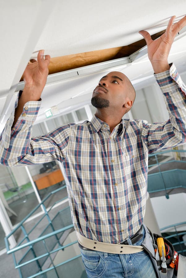 Worker repairing ceiling stock photo. Image of hands - 266081814