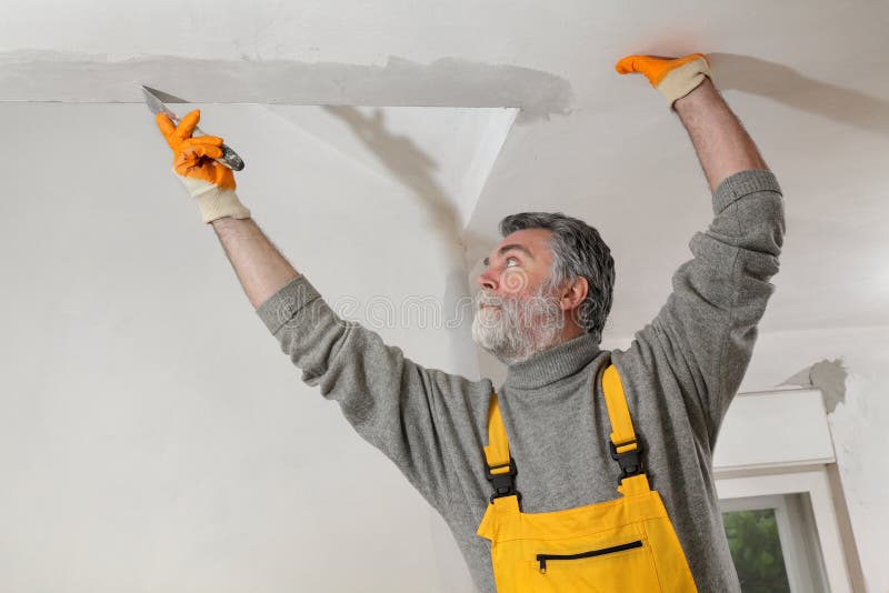 Worker Repairing Plaster at Ceiling Stock Image - Image of paint ...
