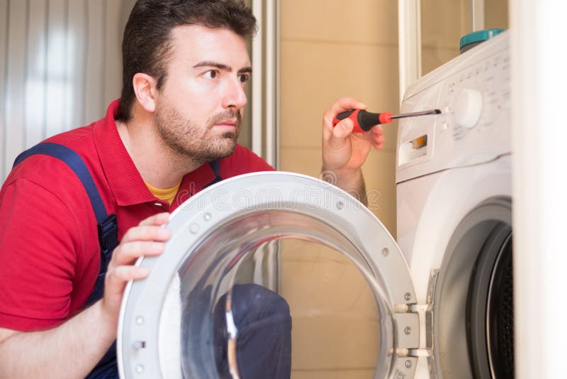 Worker Repairing the Washing Machine in the Bathroom Stock Image ...