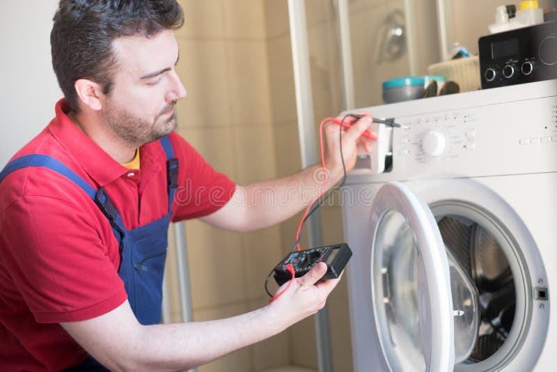 Worker Repairing the Washing Machine in the Bathroom Stock Photo ...
