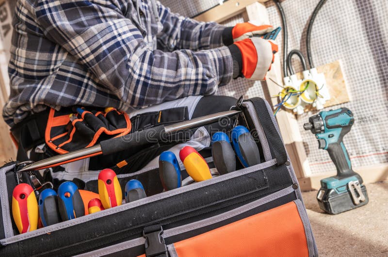 Worker Repairs Electrical Wiring with Tools in a Residential Setting ...