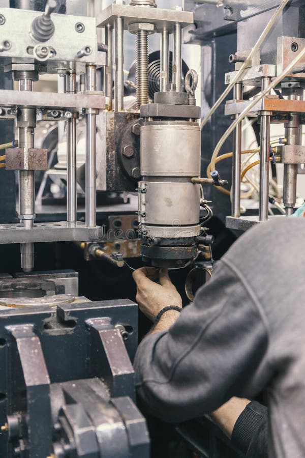 Worker Repairs a Machine for Plastic Injection Stock Photo - Image of ...
