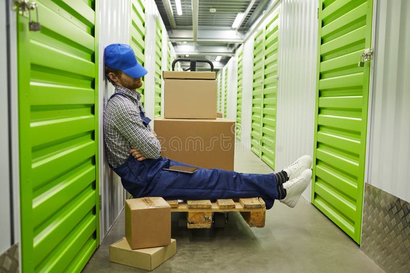 Worker Resting in Warehouse Stock Photo - Image of cardboard, packaging ...