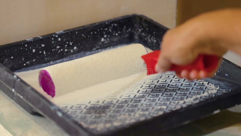 Worker Rolling Paint Roller in Primer Paint in Roller Tray Stock ...