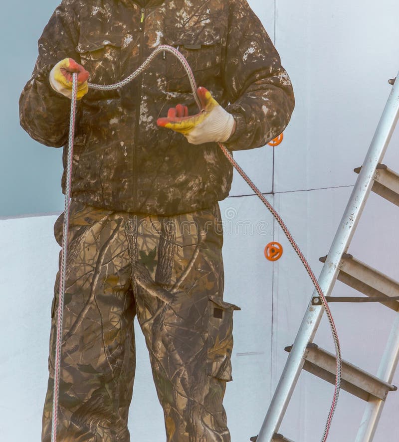 Worker with a rope in hand stock photo. Image of sand - 146907964