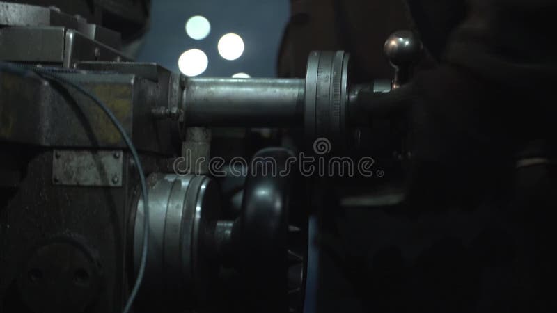 Worker Rotate Wheel on Lathe Machine. Metalworking. Turner Working on ...