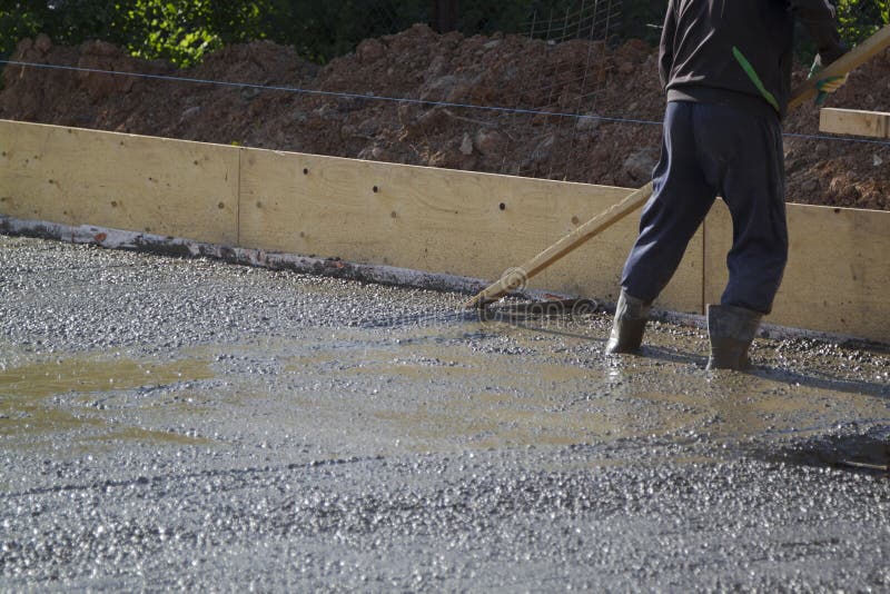 Worker in Rubber Boots Stands in Uncluttered Cement and Leveling the ...