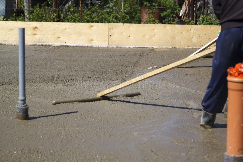 Worker in Rubber Boots Stands in Uncluttered Cement and Leveling the ...