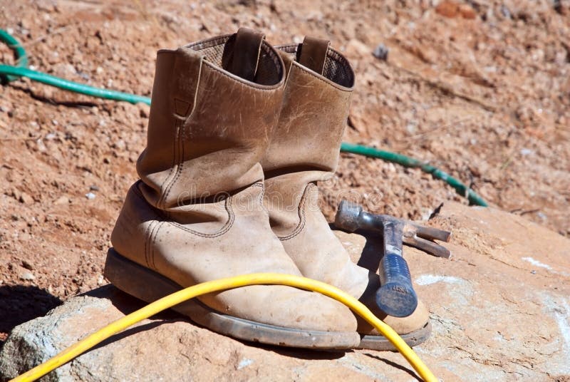 Worker s Boots and Hammer stock image. Image of outdoors - 7236419