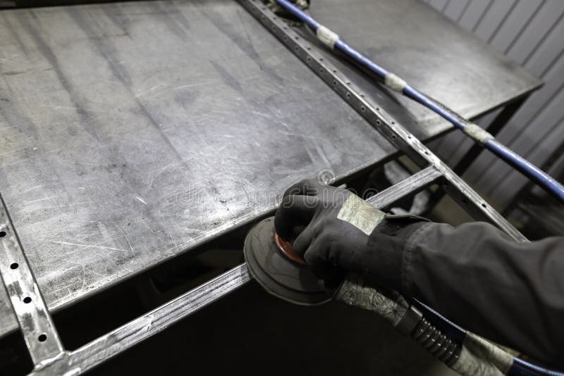 A Worker S Gloved Hand Uses a Power Sander To Smooth the Joints of a ...