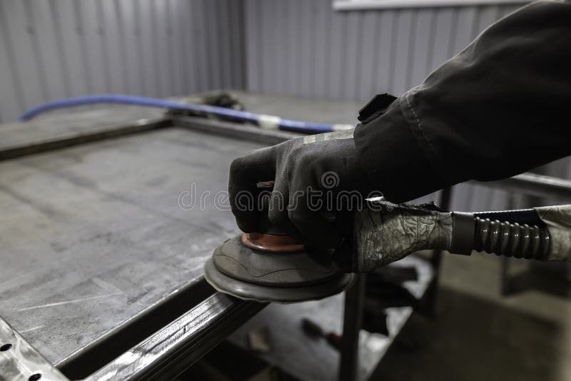 A Worker S Gloved Hand Uses a Power Sander To Smooth the Joints of a ...
