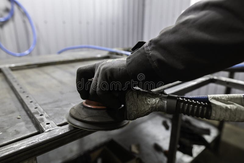 A Worker S Gloved Hand Uses a Power Sander To Smooth the Joints of a ...