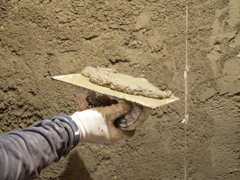 Worker`s Hand with a Mortar on a Plaster Trowel Stock Image - Image of ...