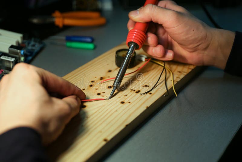 Worker`s Hands Solder with Soldering Iron in the Workshop Stock Photo ...
