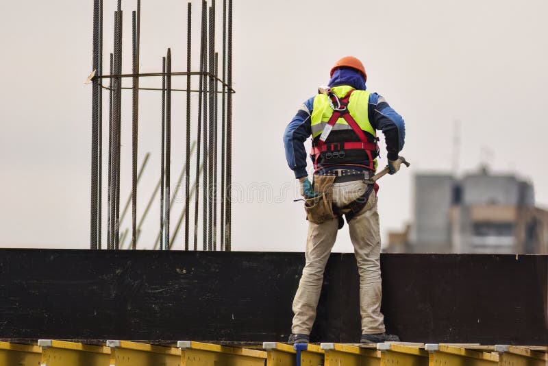Worker with Safety Belt Build Scaffolding at the Construction Site ...