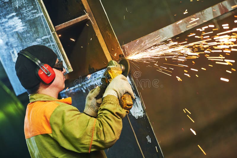 Welding and Sanding Joints. Industrial Worker Machining Weld Seam with ...