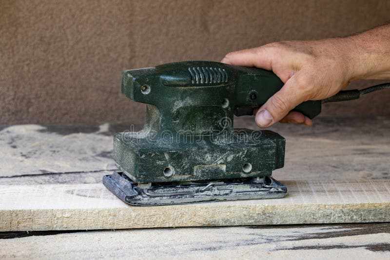 Worker Sands Wooden Boards Using a Vibration Sander in a Workshop ...
