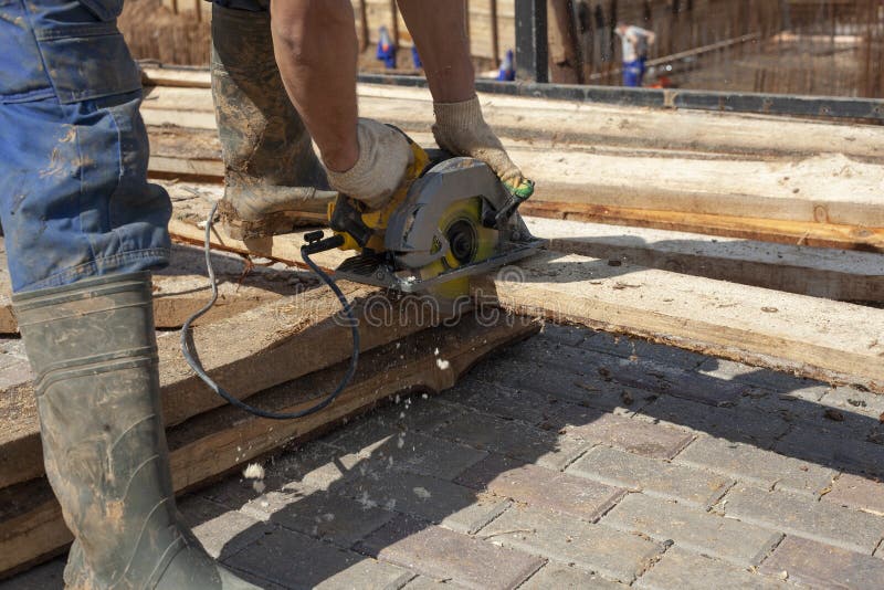 The Worker is Sawing the Boards. the Builder Prepares the Boards. Work ...