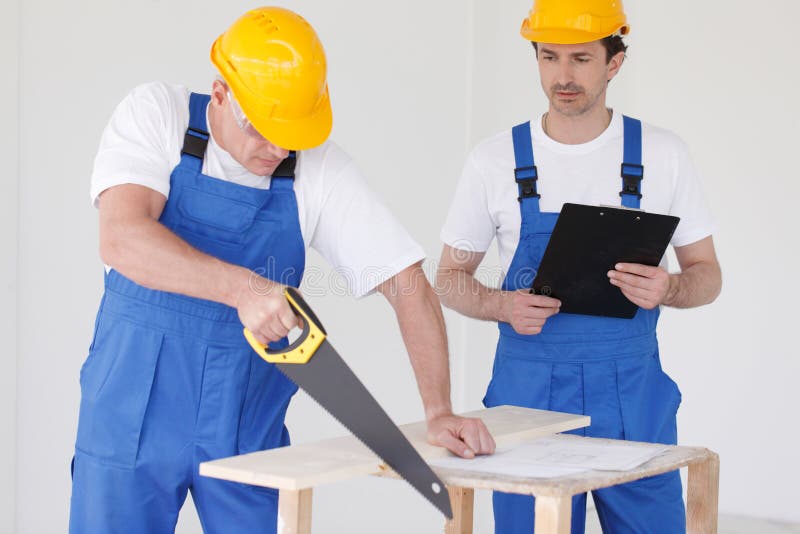 Worker sawing wooden board stock photo. Image of work - 82271592