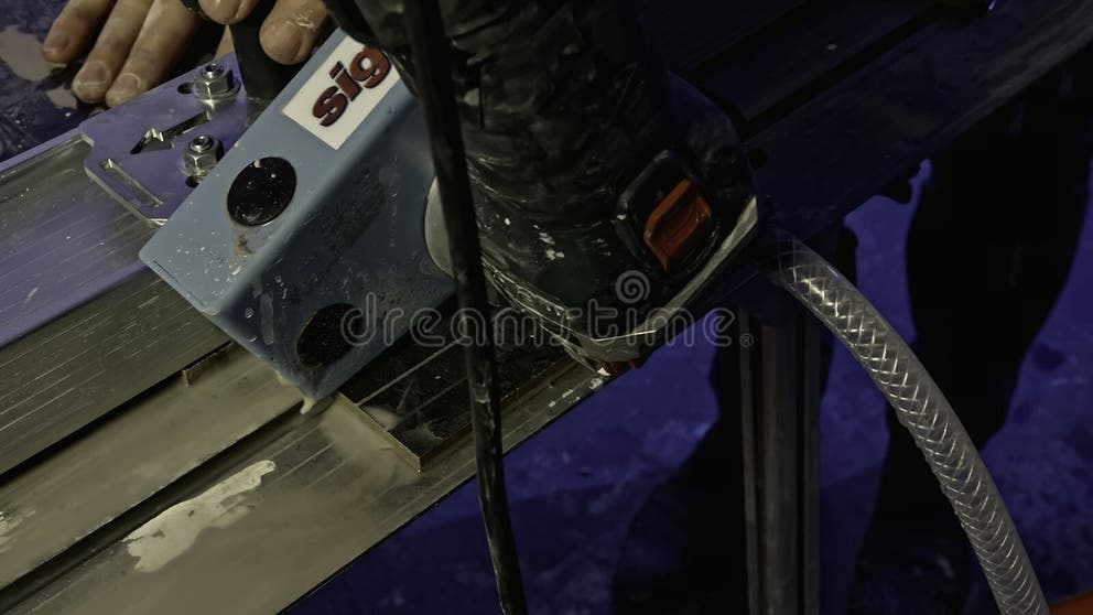 A Worker Saws Ceramic Tiles with a Grinder. Creative. Cutting Ceramics ...