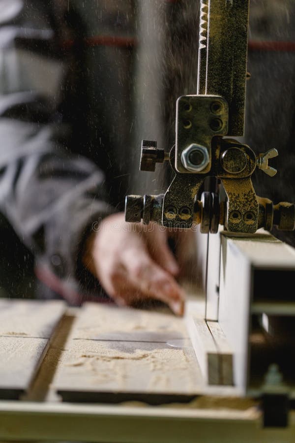The Worker Saws the Workpiece on a Jig Saw and Sawdust is Flying. Front ...