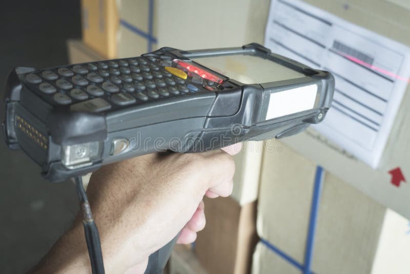 Worker Scanning Bar Code Scanner with Label of Goods. Computer ...