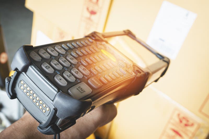 Worker Scanning Bar Code Scanner on Package Boxes. Computer Work Tools ...
