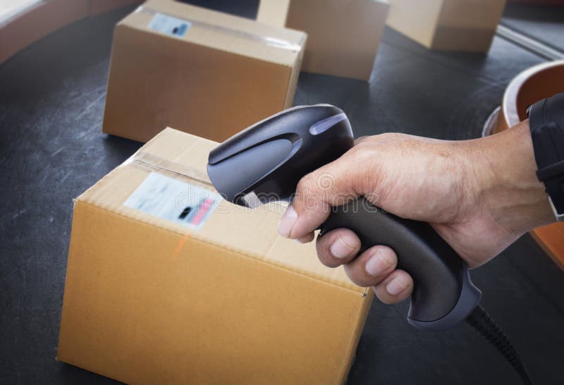 Worker Scanning Bar Code Scanner on Package Boxes. Computer WorkTools ...