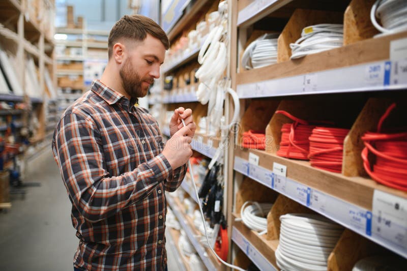 Worker Selects an Electrical Cable at a Hardware Store Stock Image ...