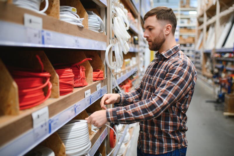 Worker Selects an Electrical Cable at a Hardware Store Stock Image ...