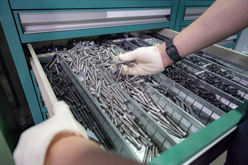 A Worker Selects and Shows Bolts Lying in a Hardware Box Stock Image ...