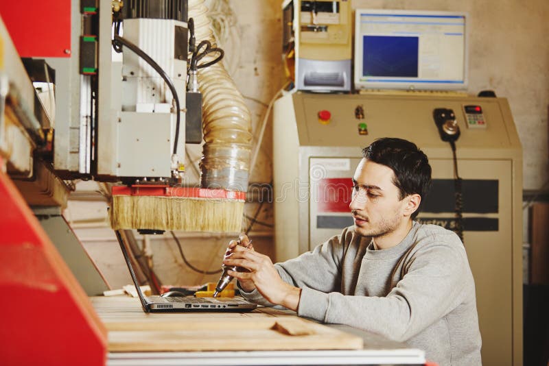 Man Sets the Cutter in Chuck for Cutting Wood. Machine with Computer ...