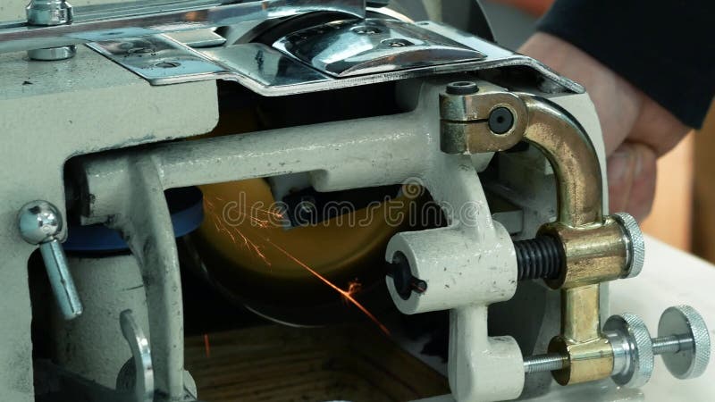 Worker Sharpening a Blade on a Skiving Machine. Adjusting Automatic ...