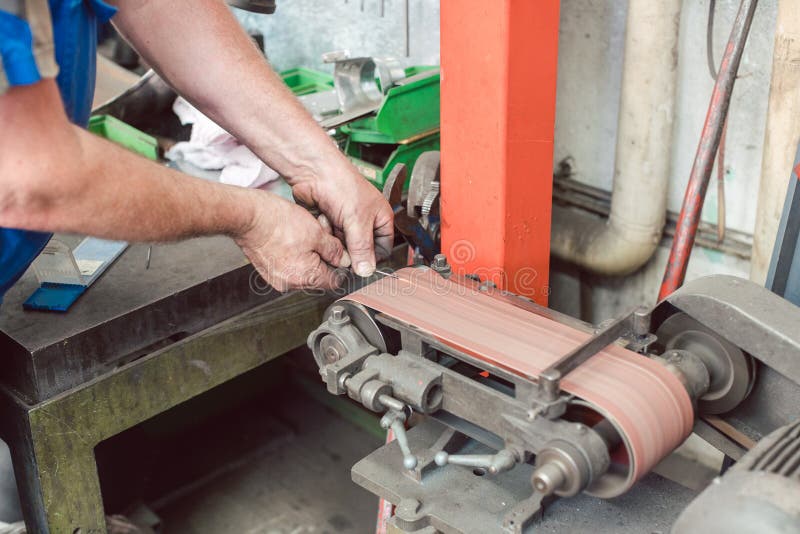 Worker Sharpening Tools in Workshop Using Grinding Paper Stock Image ...