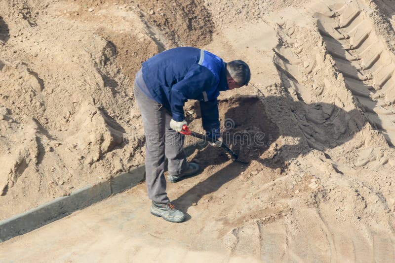 Worker with a Shovel Digging Sand Editorial Stock Photo - Image of ...