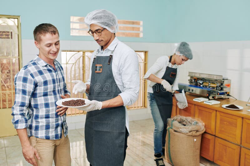Worker Showing Coffee Beans To Customer Stock Image - Image of apron ...