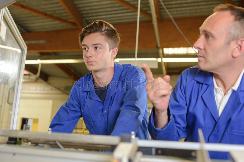 Worker Showing Machine To Apprentice Stock Photo - Image of intership ...
