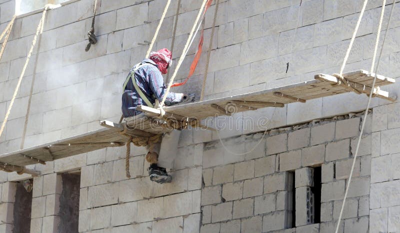 A Worker Sits Hanging on a Construction Scaffold Stock Photo - Image of brickwork, construction ...