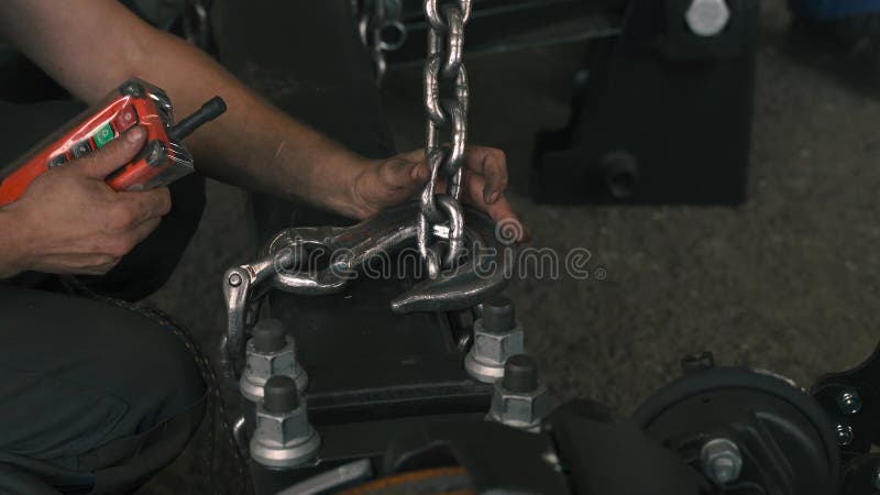 A Worker Skillfully Manages a Winch Control Hook during Heavy Machinery ...