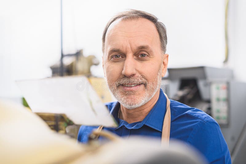 Worker Smiling while Looking at the Camera Stock Photo - Image of ...