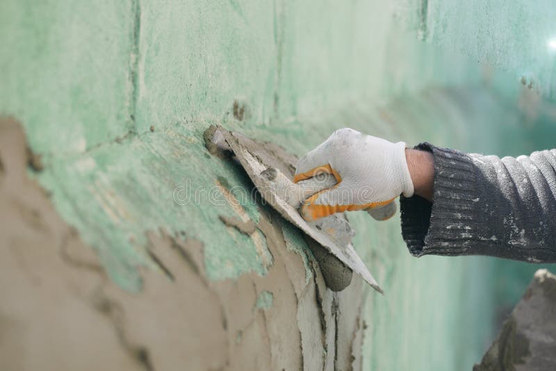 A Worker Smooths Plaster on a Wall in a Renovation Project Stock Photo ...