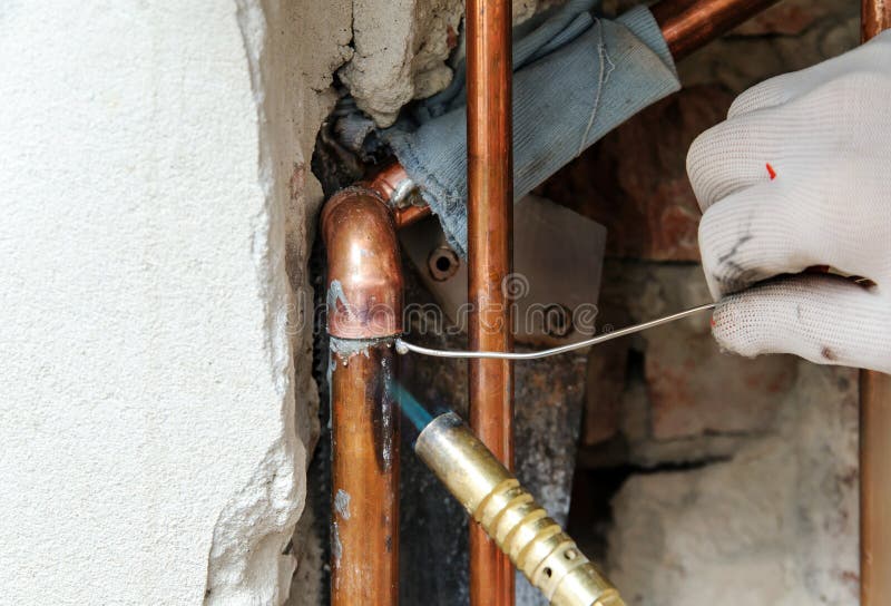 A Worker is Soldering Copper Pipes. Stock Image - Image of renovation ...