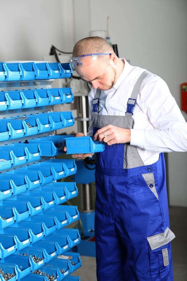 Worker Sorting Parts in Storage Bins. Stock Photo - Image of automation ...