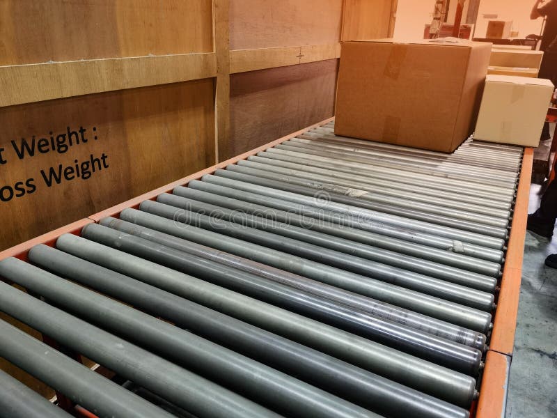 Worker Sorting Shipment Cartons Box on Conveyor Belt in Interior ...