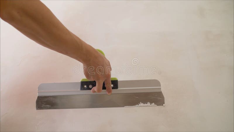 Worker Spackles the Walls with a Spatula. Spatula with Putty in Hand ...