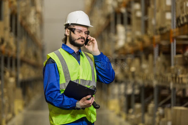 Warehouse Worker Using Mobile Phone Stock Image - Image of cellphone ...