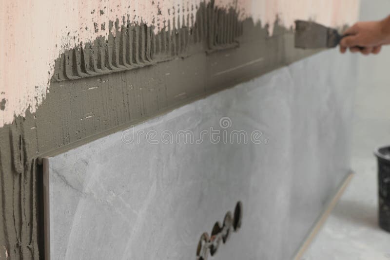 Worker Spreading Adhesive Mix on Wall, Closeup. Tiles Installation ...