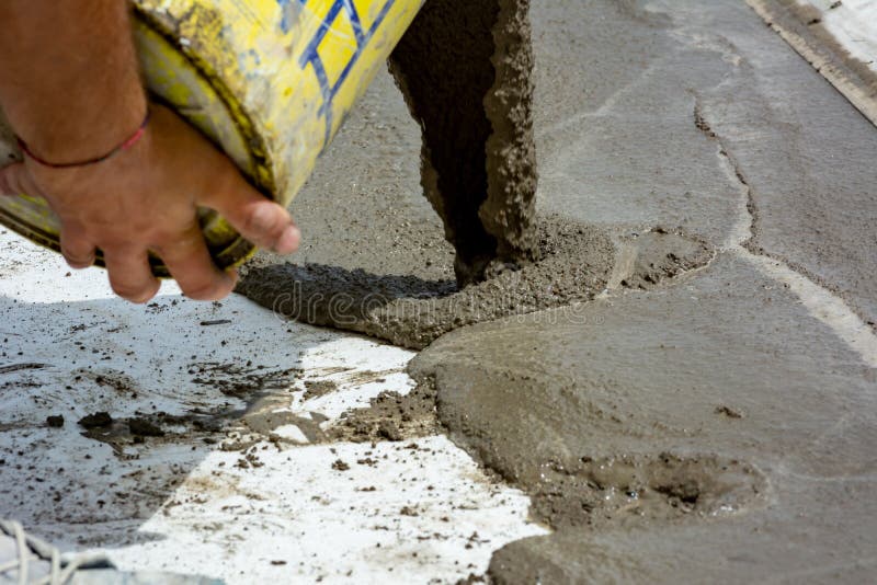Worker Spreading Building Screed on a Floor of a House during Energy ...