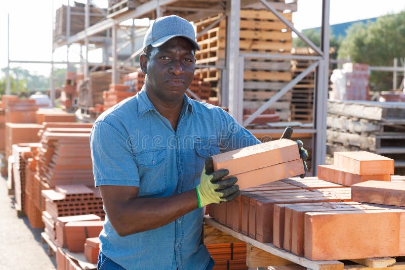 Worker Stacking Bricks in Warehouse of Building Materials Clpseup Stock ...